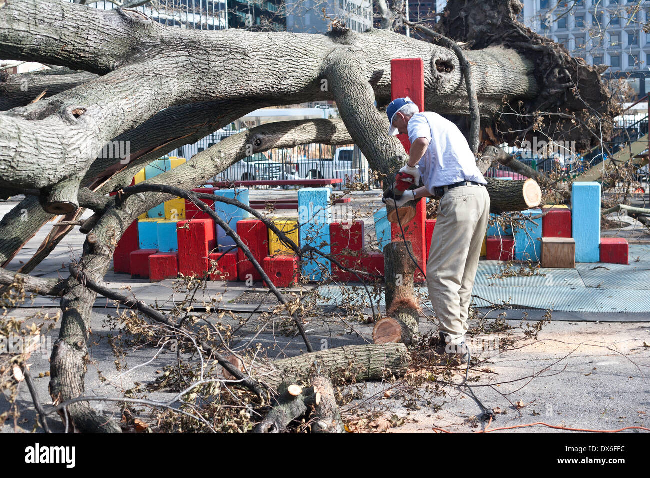 Atmosphere Work continues on a large tree that has fallen onto the ...