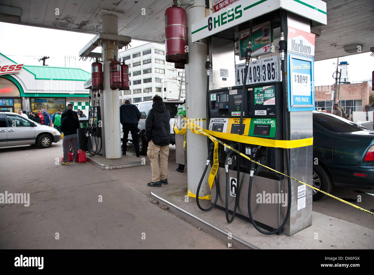 Atmosphere Police officers oversee the orderly distribution of fuel at ...