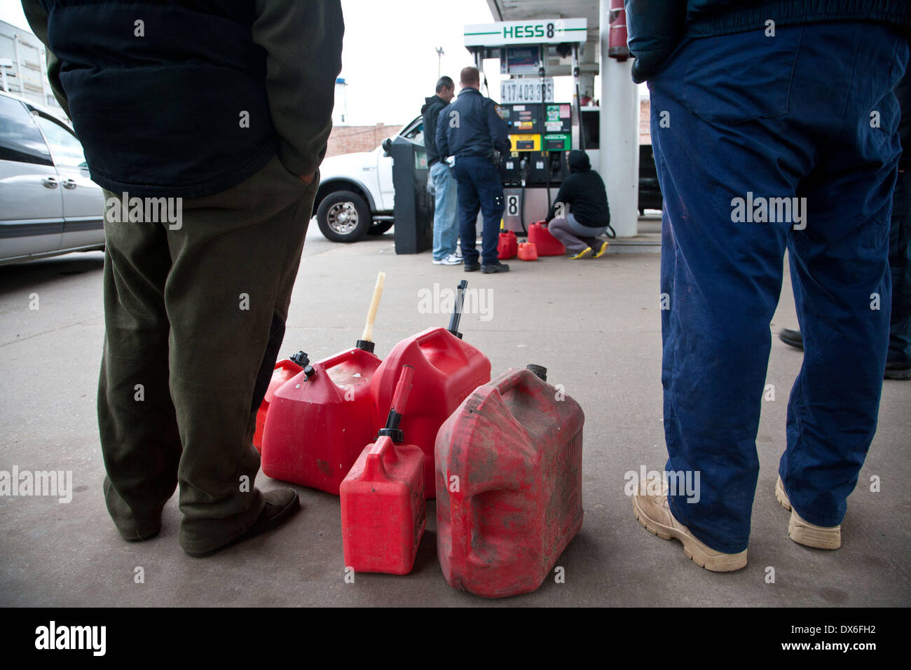 Atmosphere Police officers oversee the orderly distribution of fuel at ...