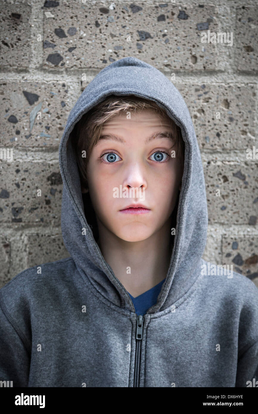 portrait of a male teenager with wide eyed in front of a wall Stock ...