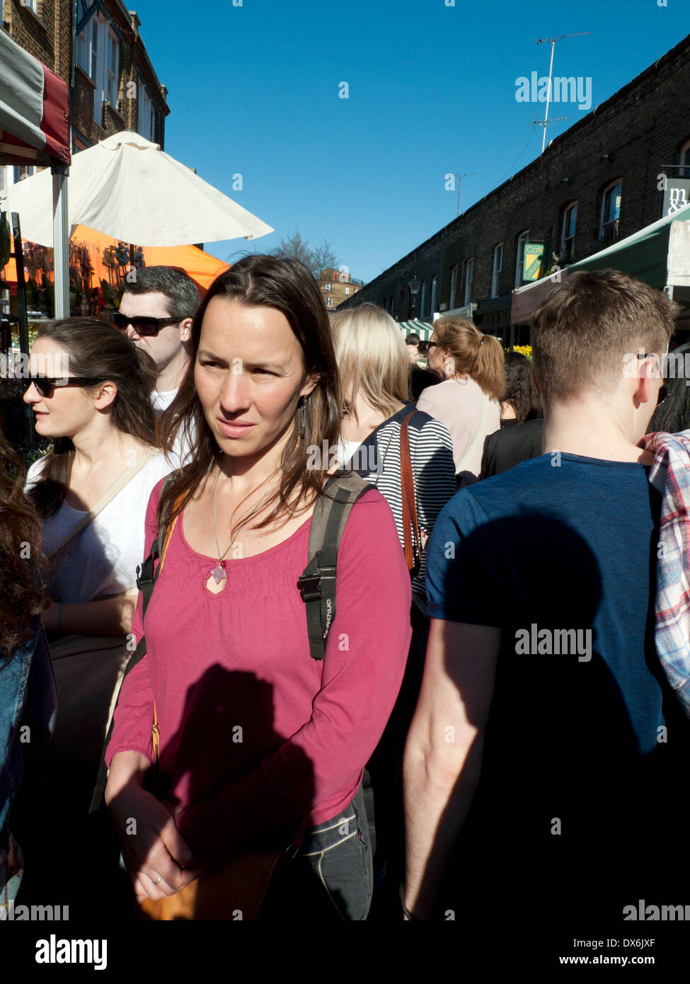 Woman walking crowded street hi-res stock photography and images - Alamy