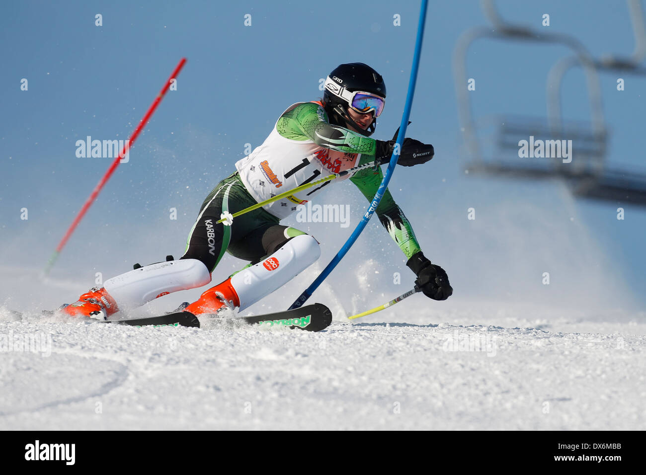 An alpine skier at a gate while racing on the slalom course Stock Photo ...