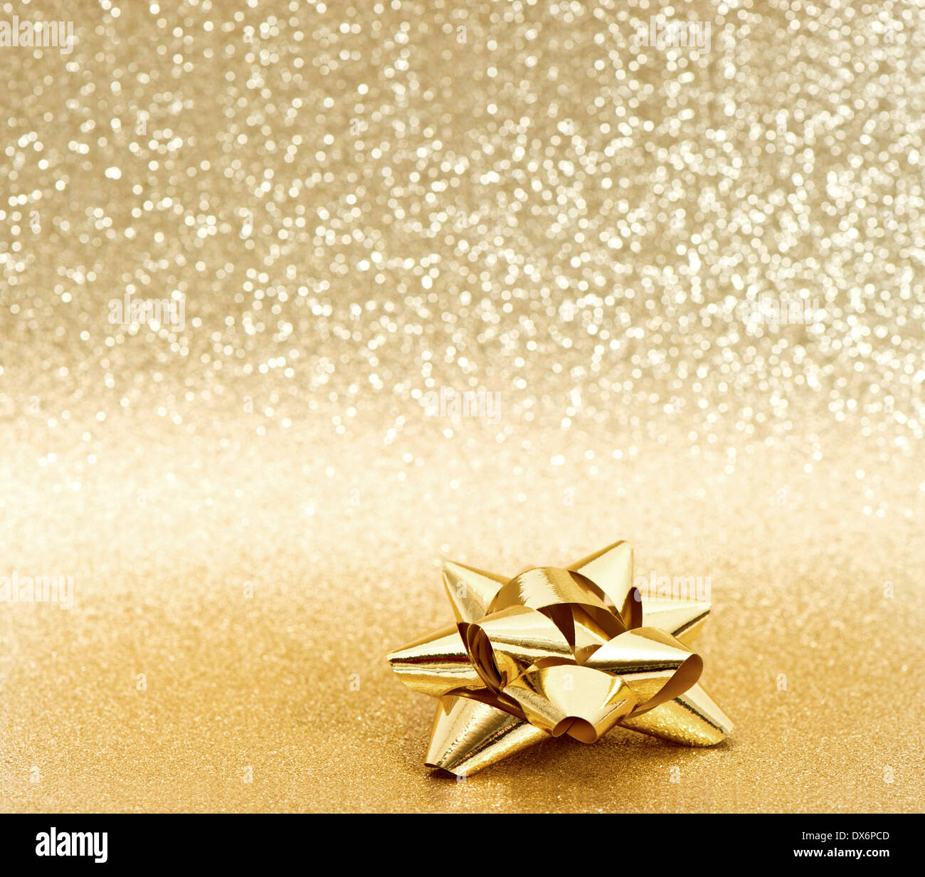 beautiful golden ribbon bow on shiny background Stock Photo - Alamy
