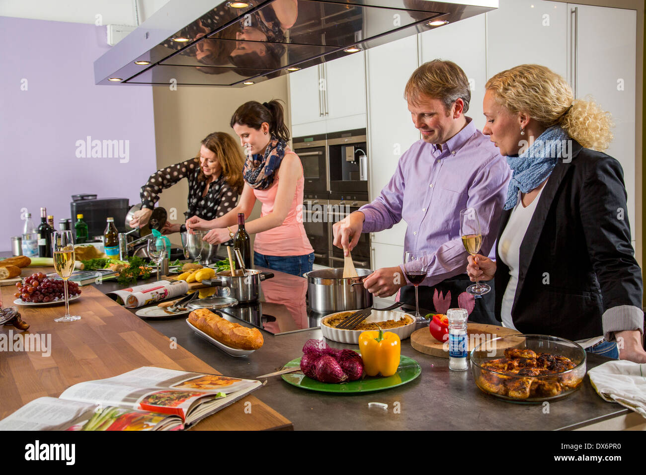 Friends cooking together in a kitchen. Preparing a meal together, self ...
