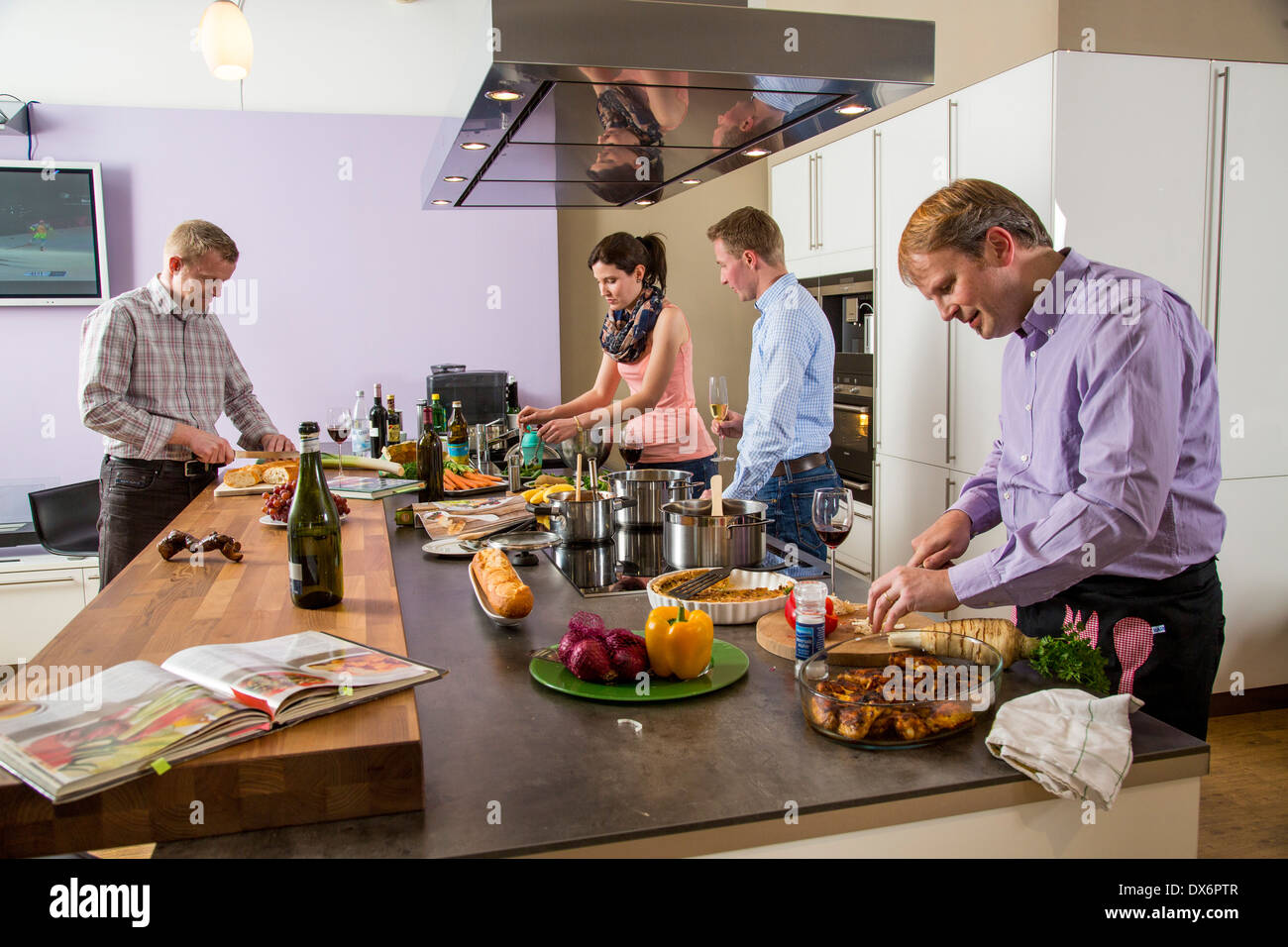 Friends cooking together in a kitchen. Preparing a meal together, self ...