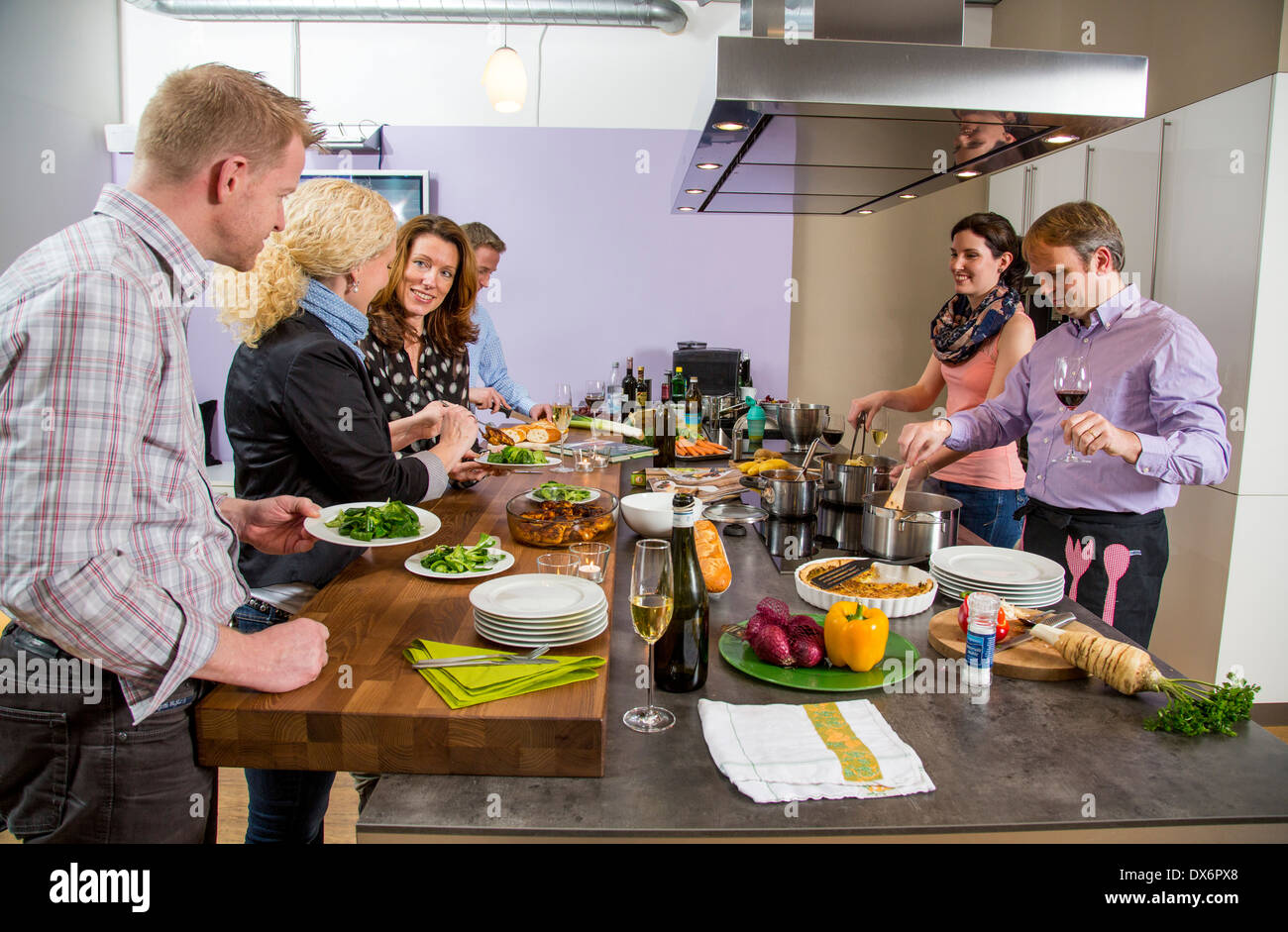 Friends cooking together in a kitchen. Preparing a meal together, self ...