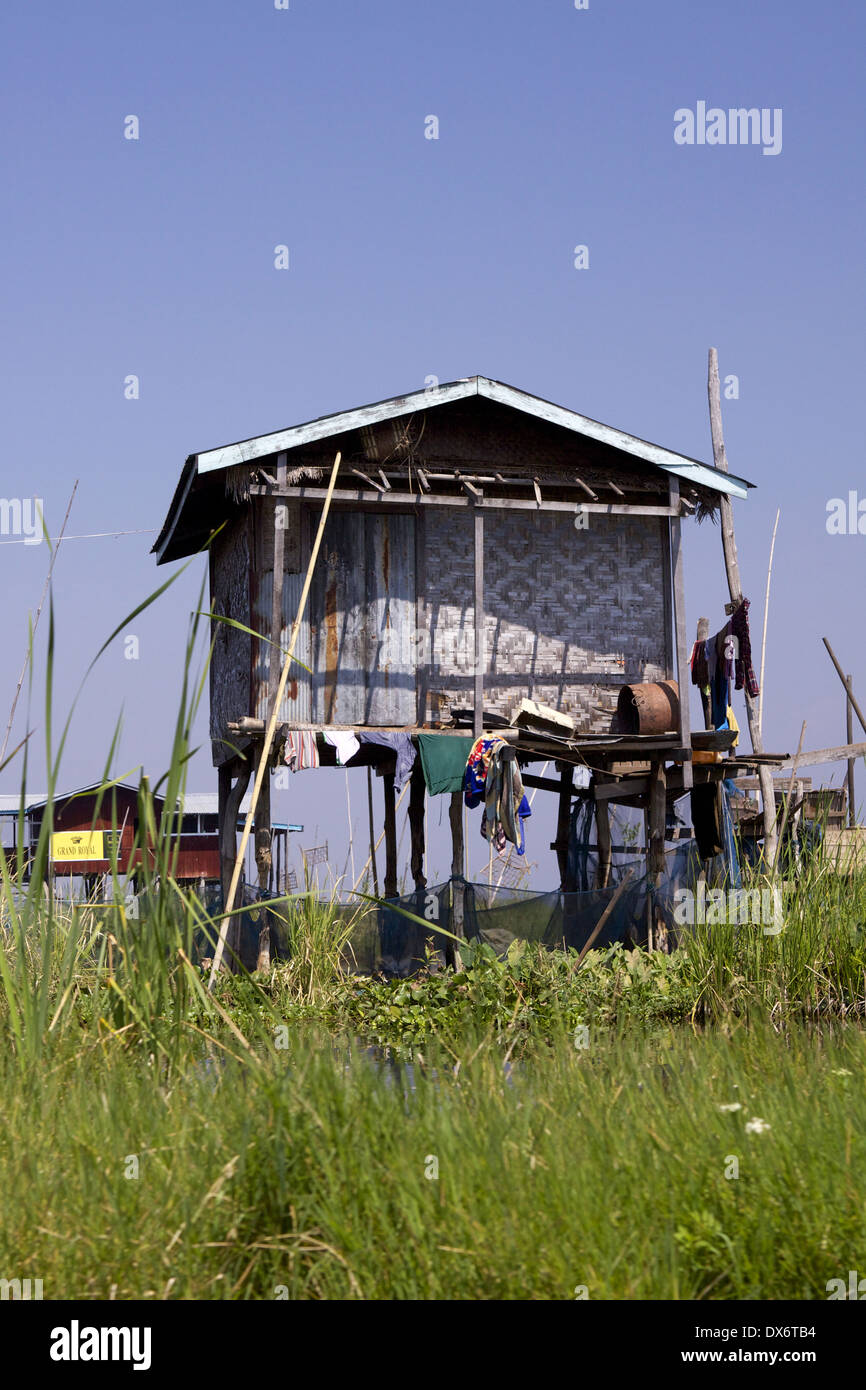 Traditional stilt house above the reed and water on Inle Lake Stock ...