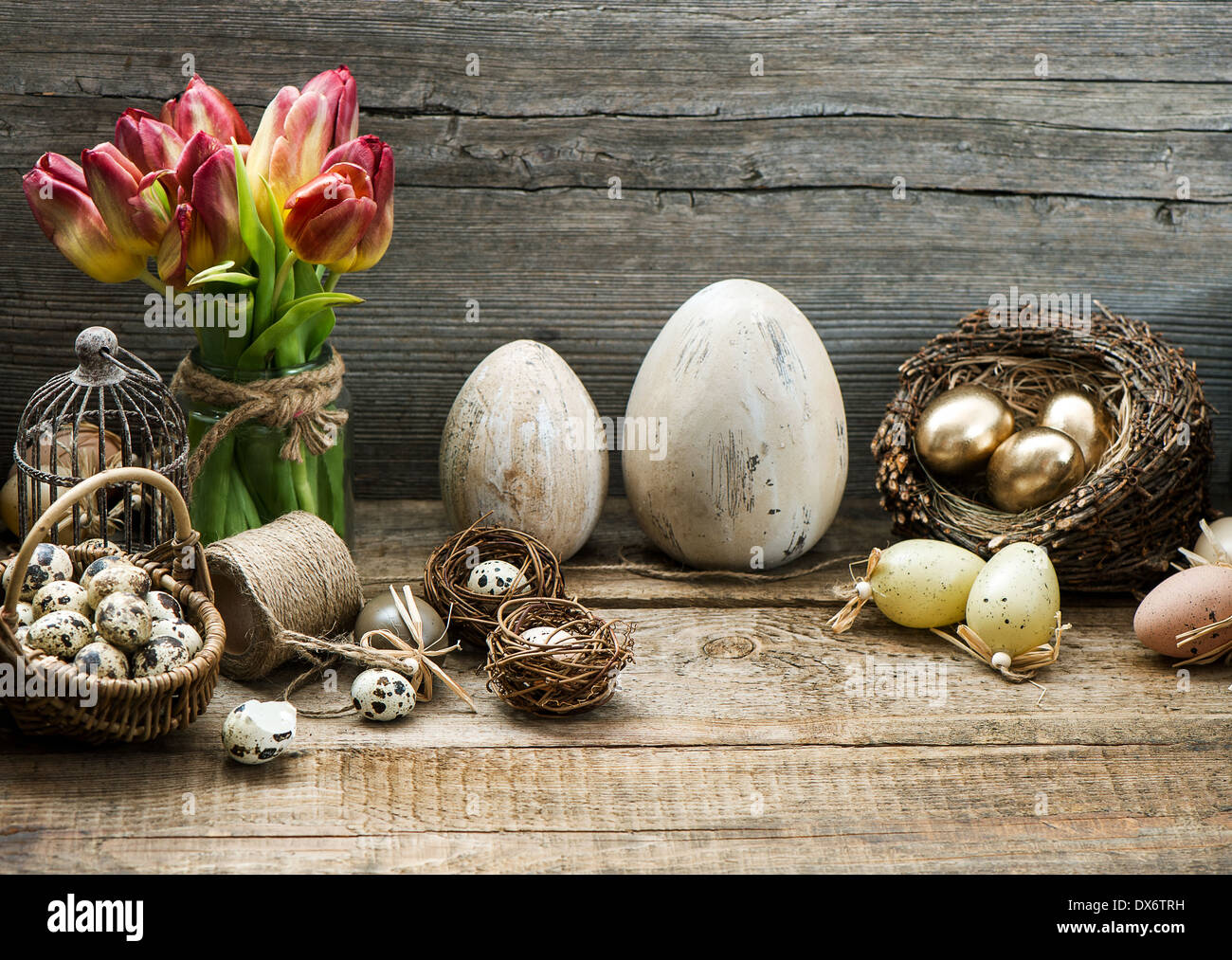 vintage easter decoration with golden eggs and red tulip flowers Stock ...