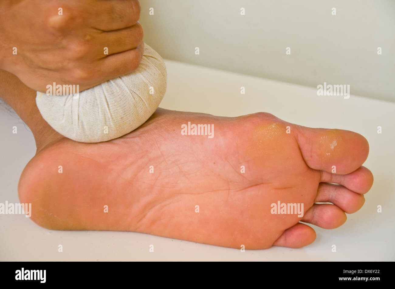 foot massage with herbal compress ball Stock Photo - Alamy