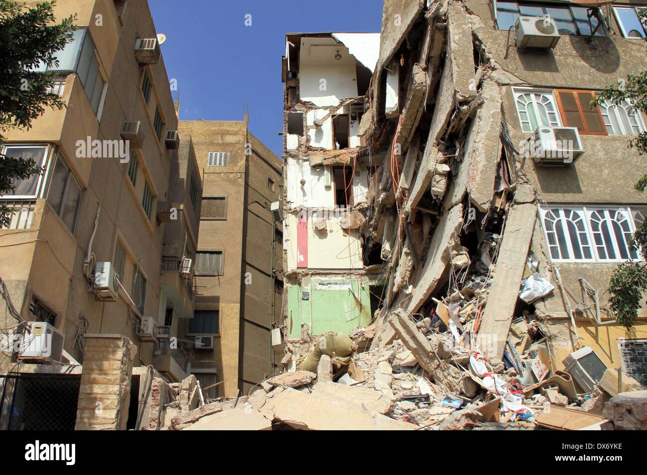 Cairo, Egypt. 19th Mar, 2014. The remains of a collapsed building is ...