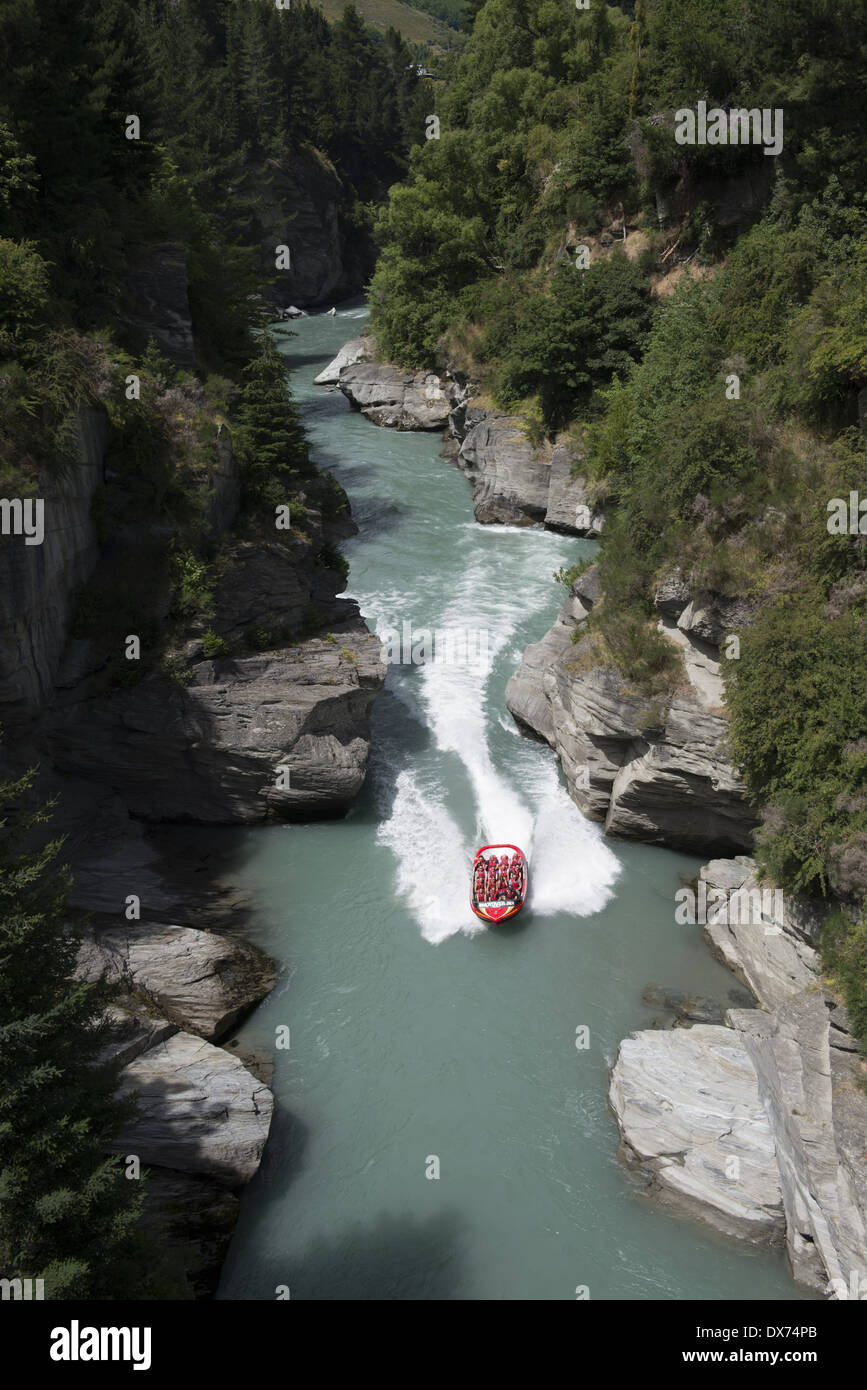The Shotover River flowing through the Shotover Gorge. A jet boat in ...
