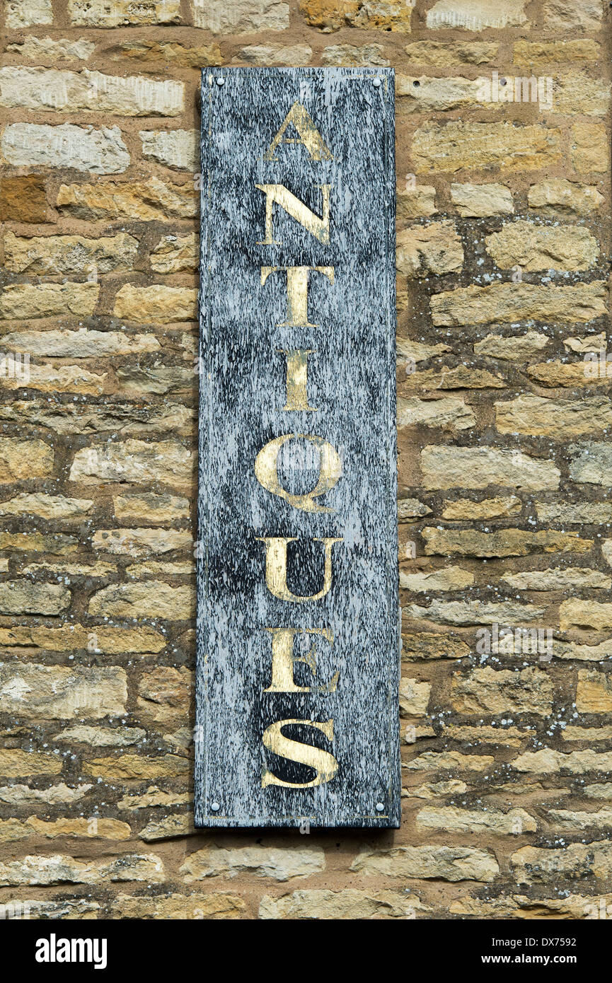 Gilded Antiques shop sign on cotswold stone wall, Stow on the Wold ...