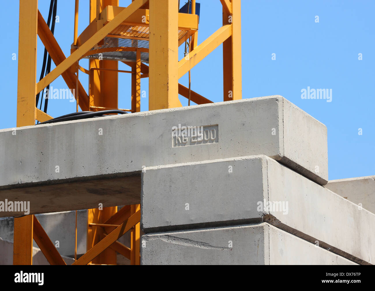 Construction crane with heavy contrablocks and blue sky Stock Photo - Alamy