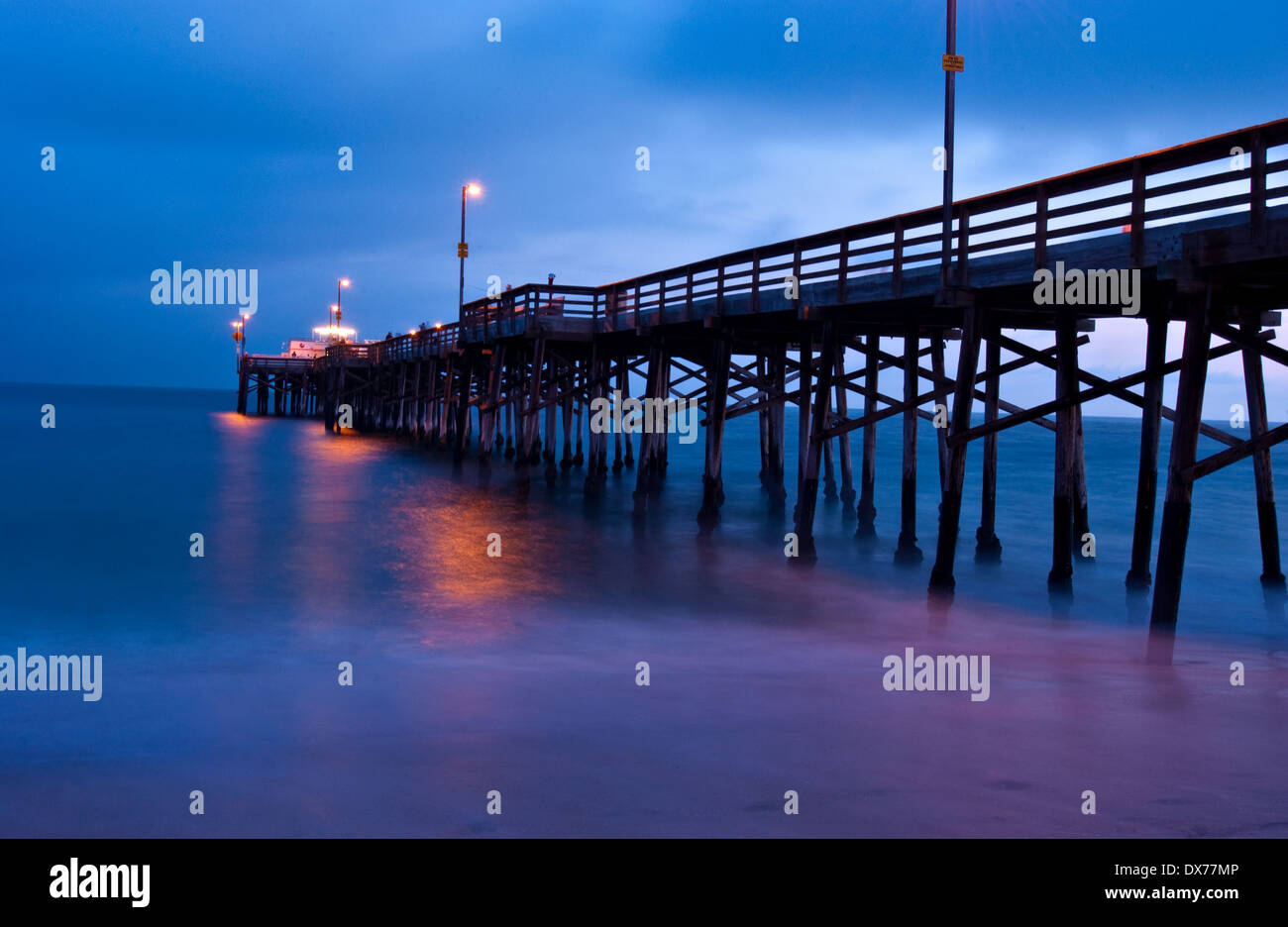 Sunset as seen from shore, looking out directly at Balboa Pier, Newport ...