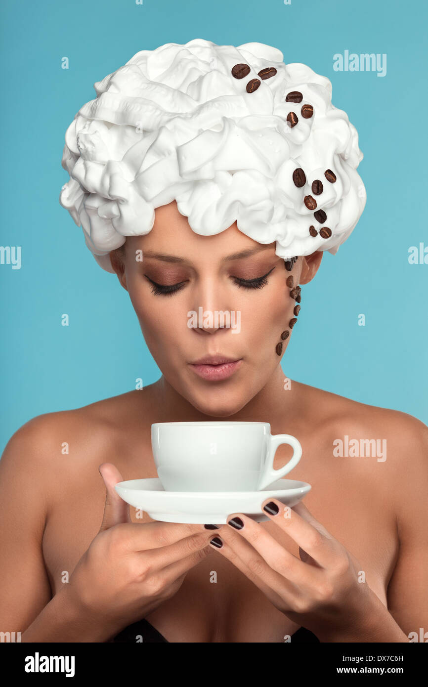 A young lady in a whipped cream on her head with a coffee cup Stock ...