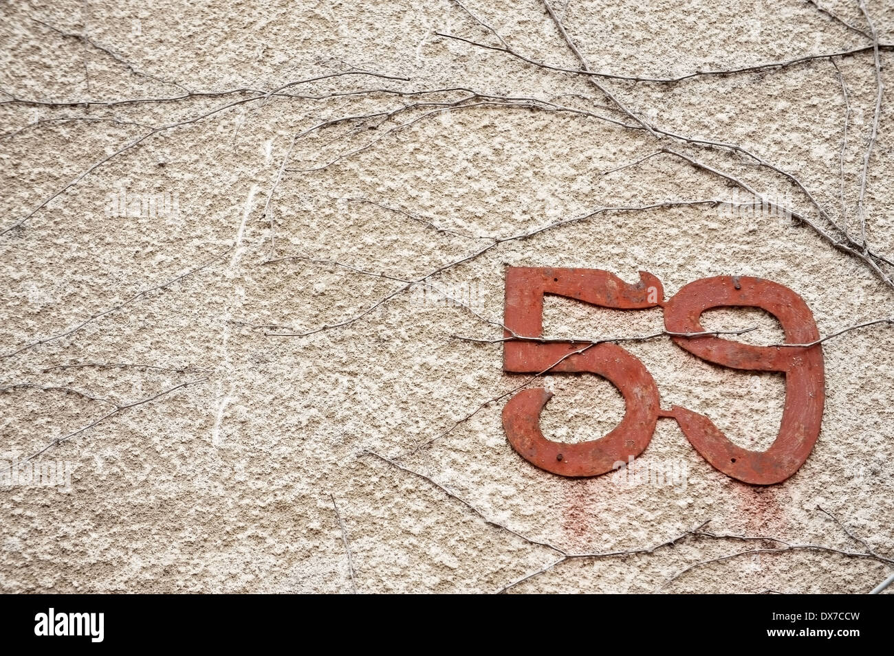 Old and rusty street number on a wall Stock Photo - Alamy