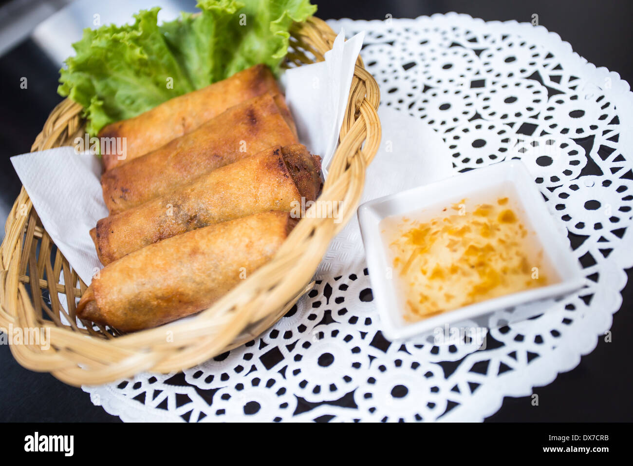 Fried Spring Rolls (Por Pia Tod) with sweet syrup sauce on black table ...