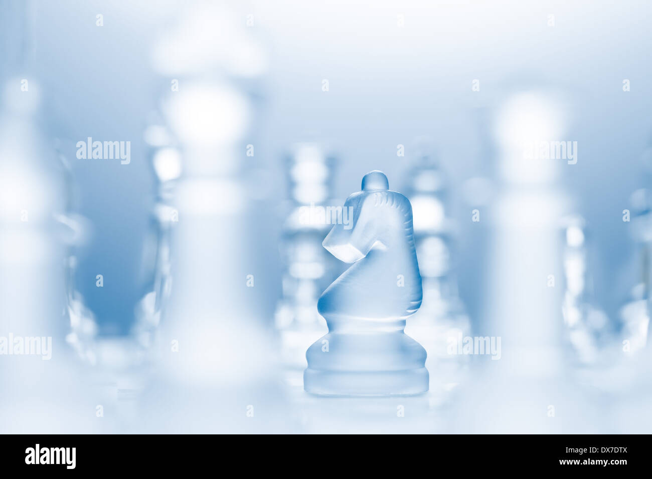 A conceptual photo of a transparent knight on a chessboard making an l ...