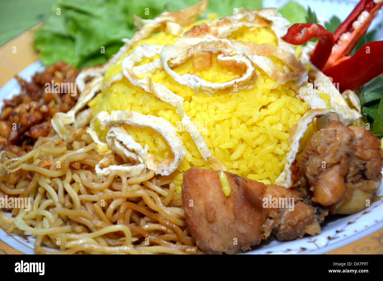 yellow rice complete with side dishes, a Indonesian traditional cuisine ...