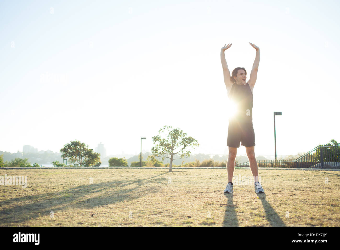 A young male stretching during an early morning work-out Stock Photo ...