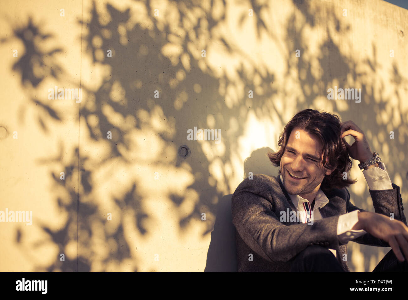 Male model sitting wall hi-res stock photography and images - Alamy