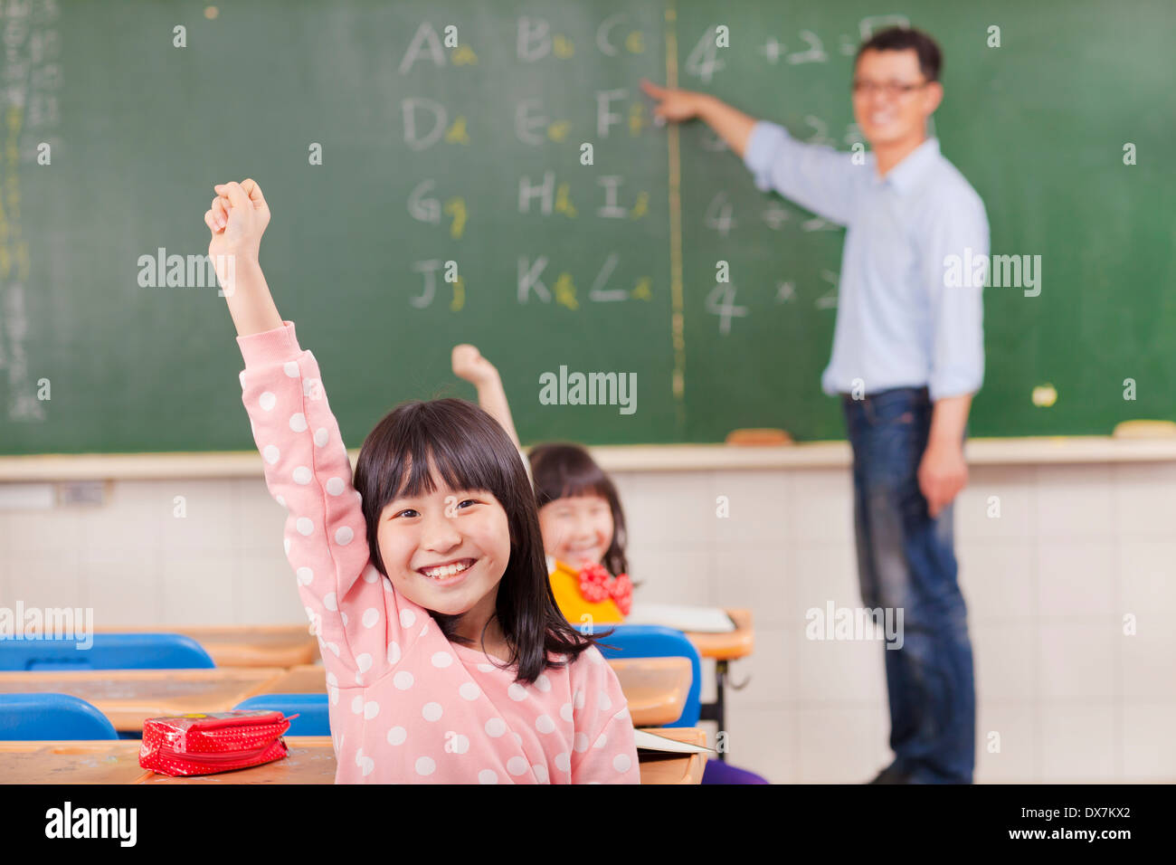 Child raising hand classroom hi-res stock photography and images - Alamy