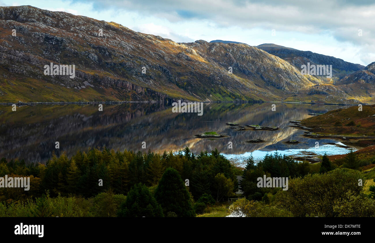 Reflections of the highlands hills in a loch in Northern Scotland Stock ...