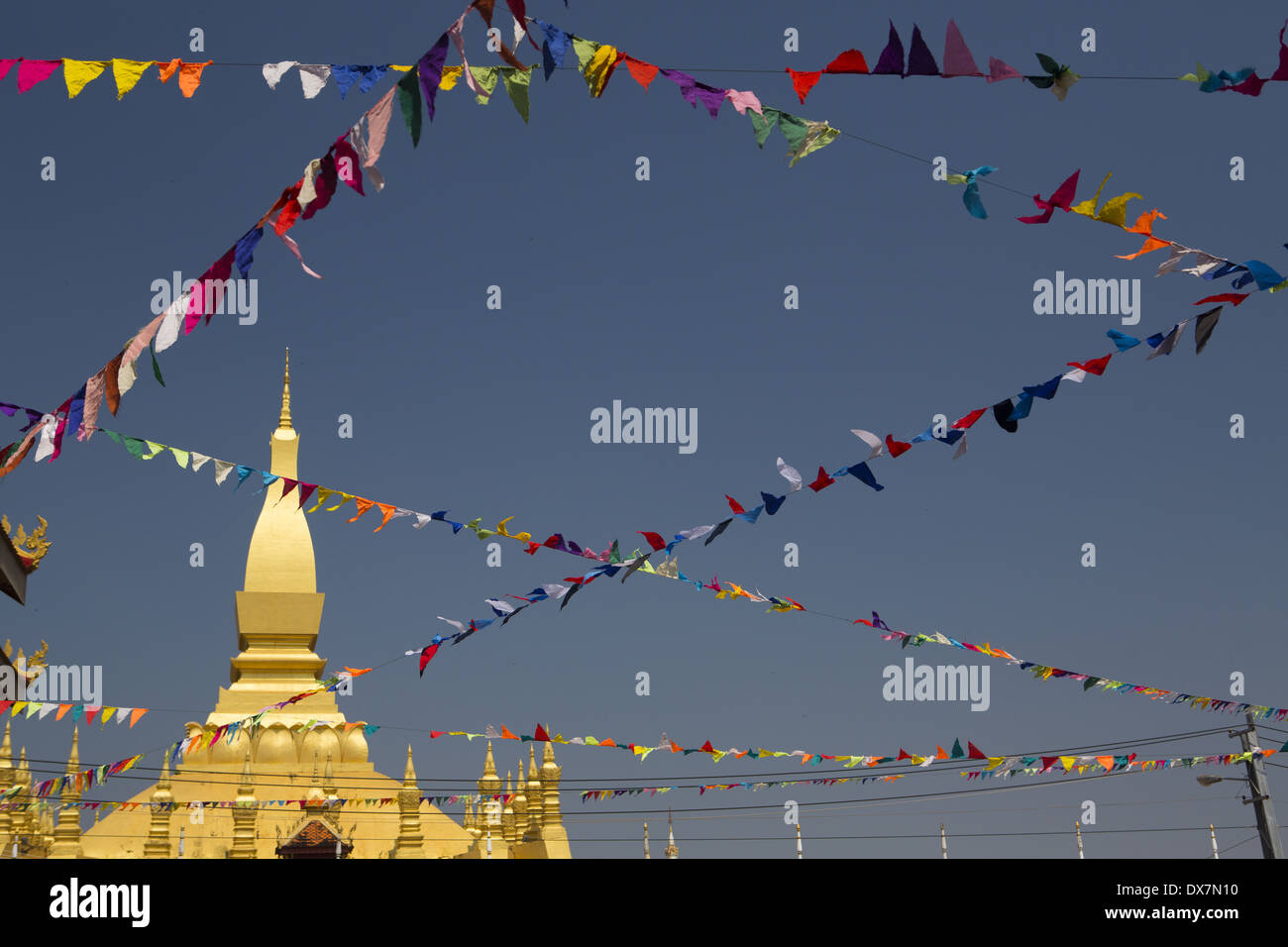 Pha That Luang Temple in Vientaine, Laos with colourful prayer flags ...