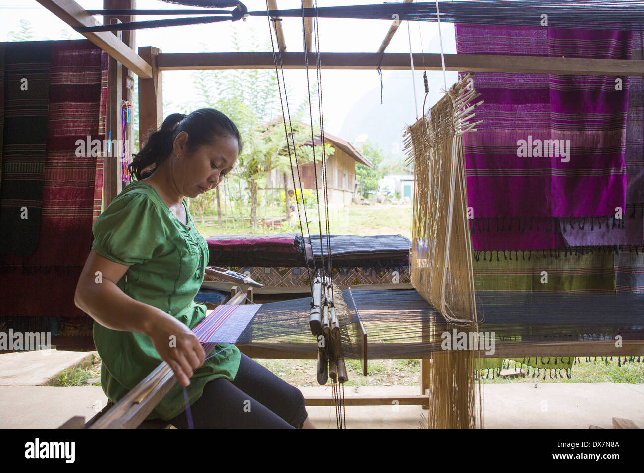 Lao woman making traditional fabric on her loom near Vang Vieng, Laos ...