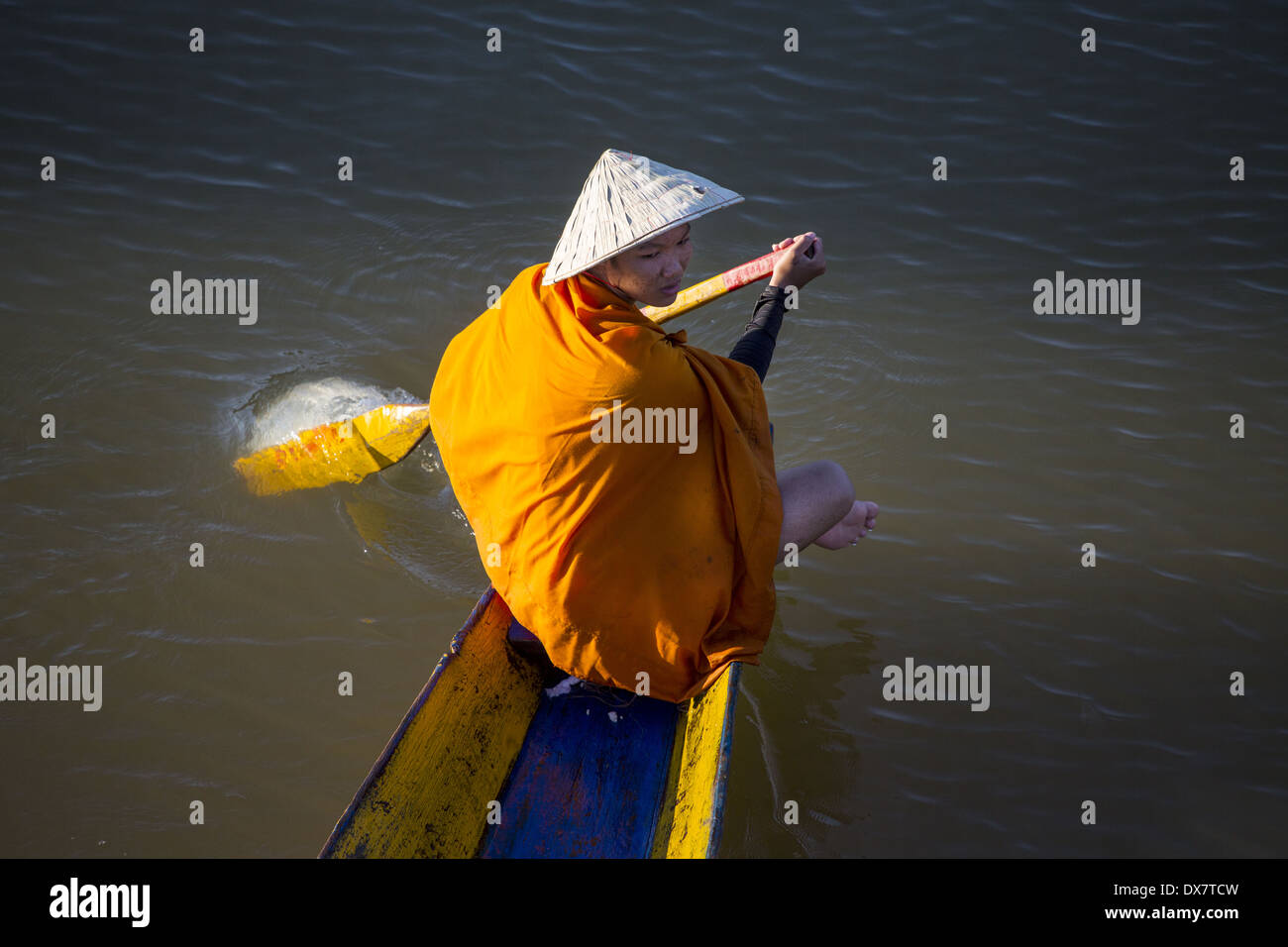 Buddhist monks on a row boat on the Mekong River in Paske, Laos Stock ...