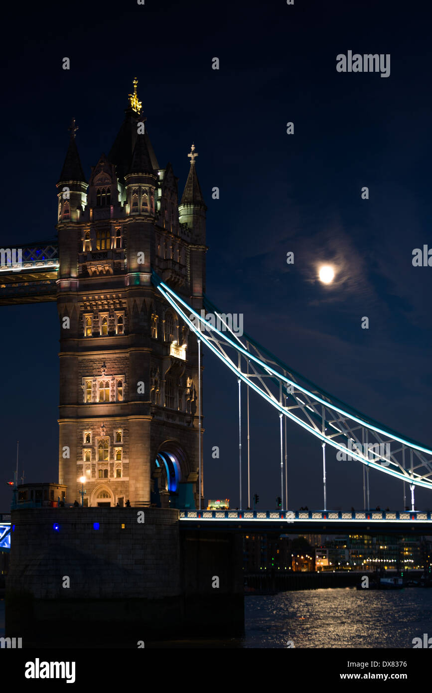 The moon rising behind Tower Bridge, famous landmark bridge crossing ...