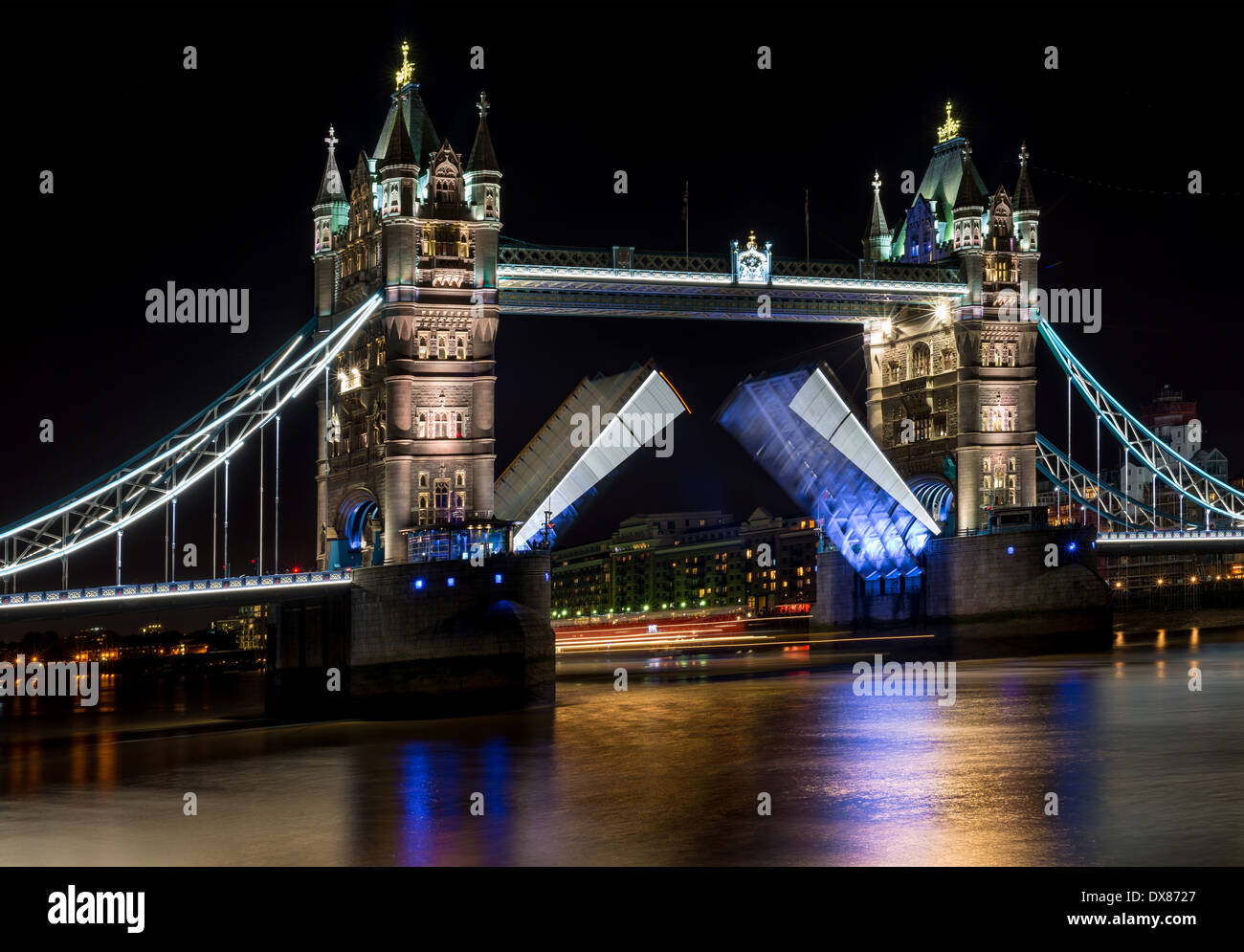 Tower Bridge in the raised position lit up at night Stock Photo - Alamy