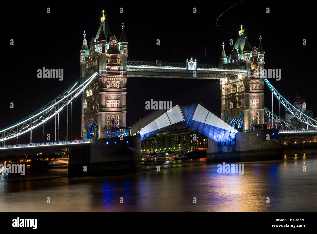 Tower Bridge in the raised position lit up at night Stock Photo - Alamy