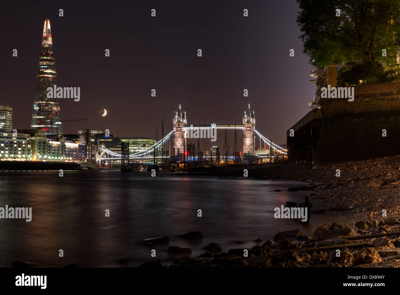 Moon sets over Tower Bridge and the Shard viewed from the banks of the ...