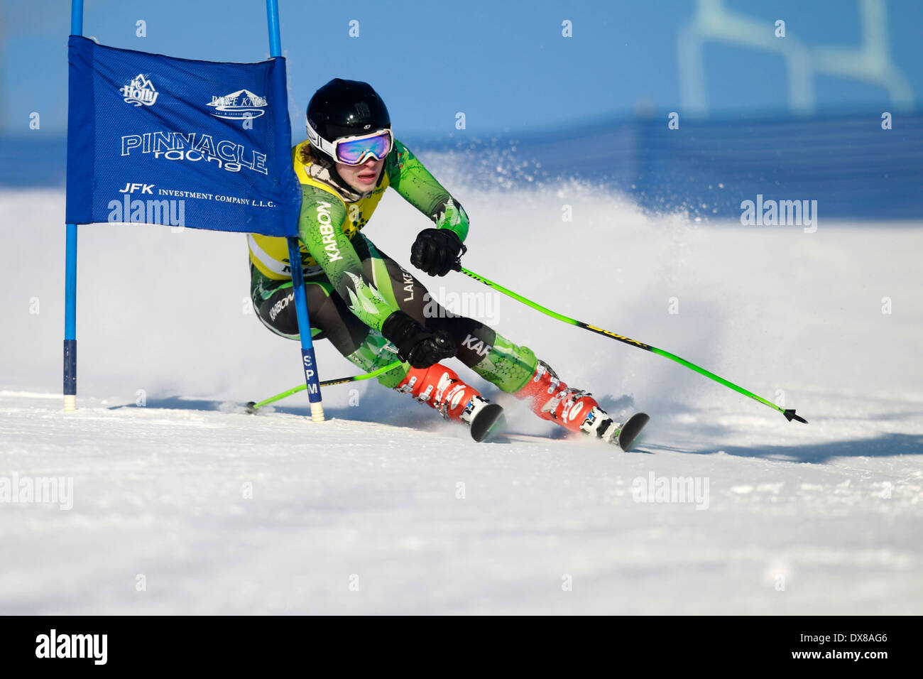 An alpine skier at a gate while racing on the giant slalom course Stock ...