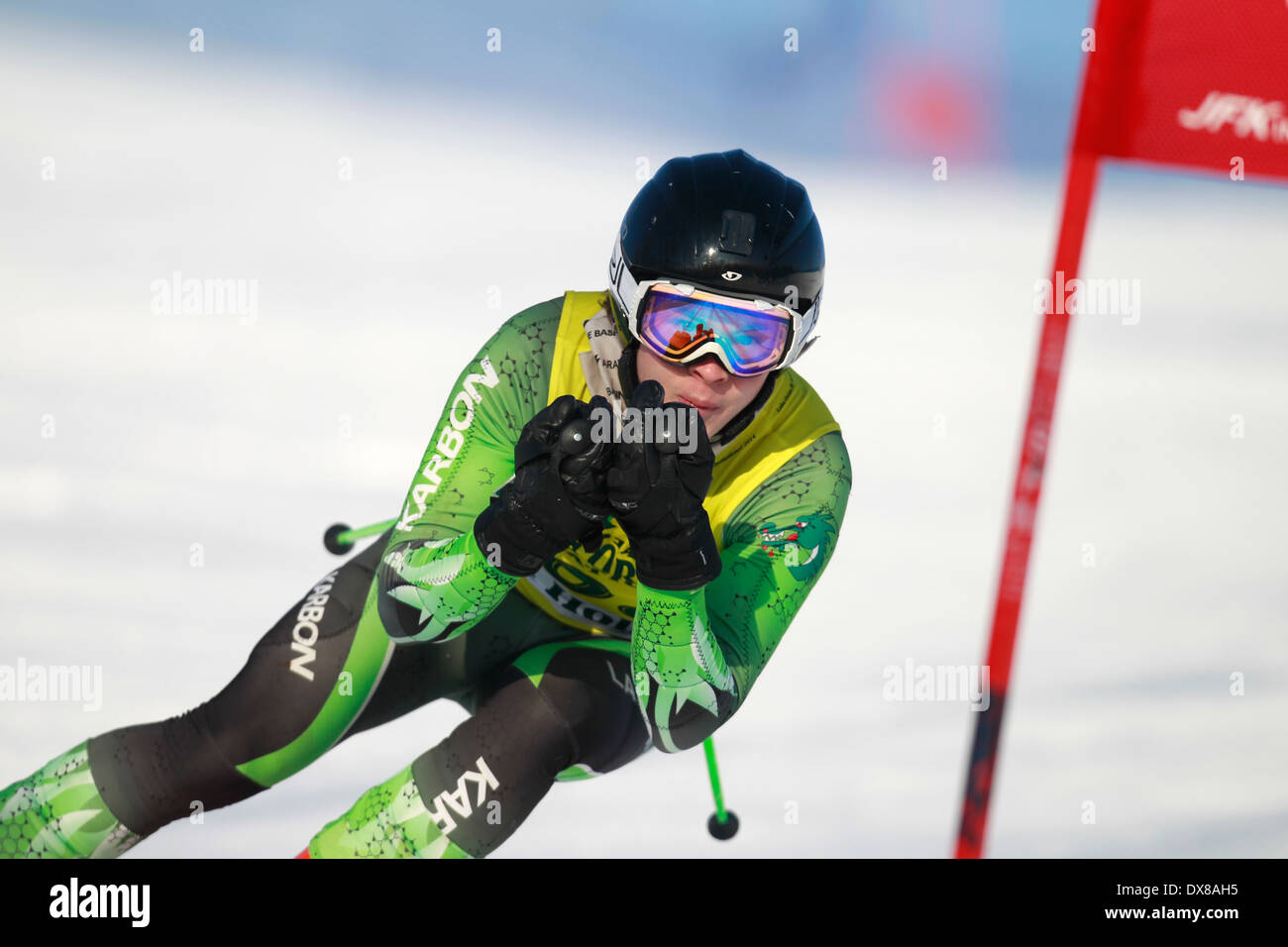 A close-up of an alpine skier approaching a gate while racing on the ...