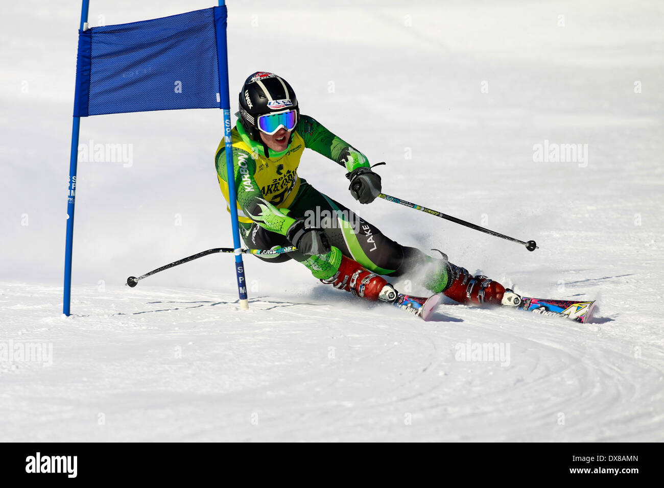 An alpine skier rounding a gate while racing on the giant slalom course ...