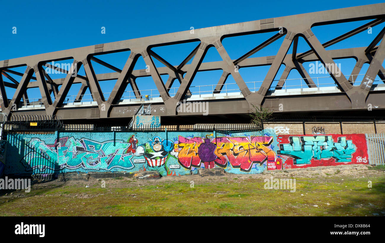 Graffiti adorns hoardings beneath the new East London Line extension ...