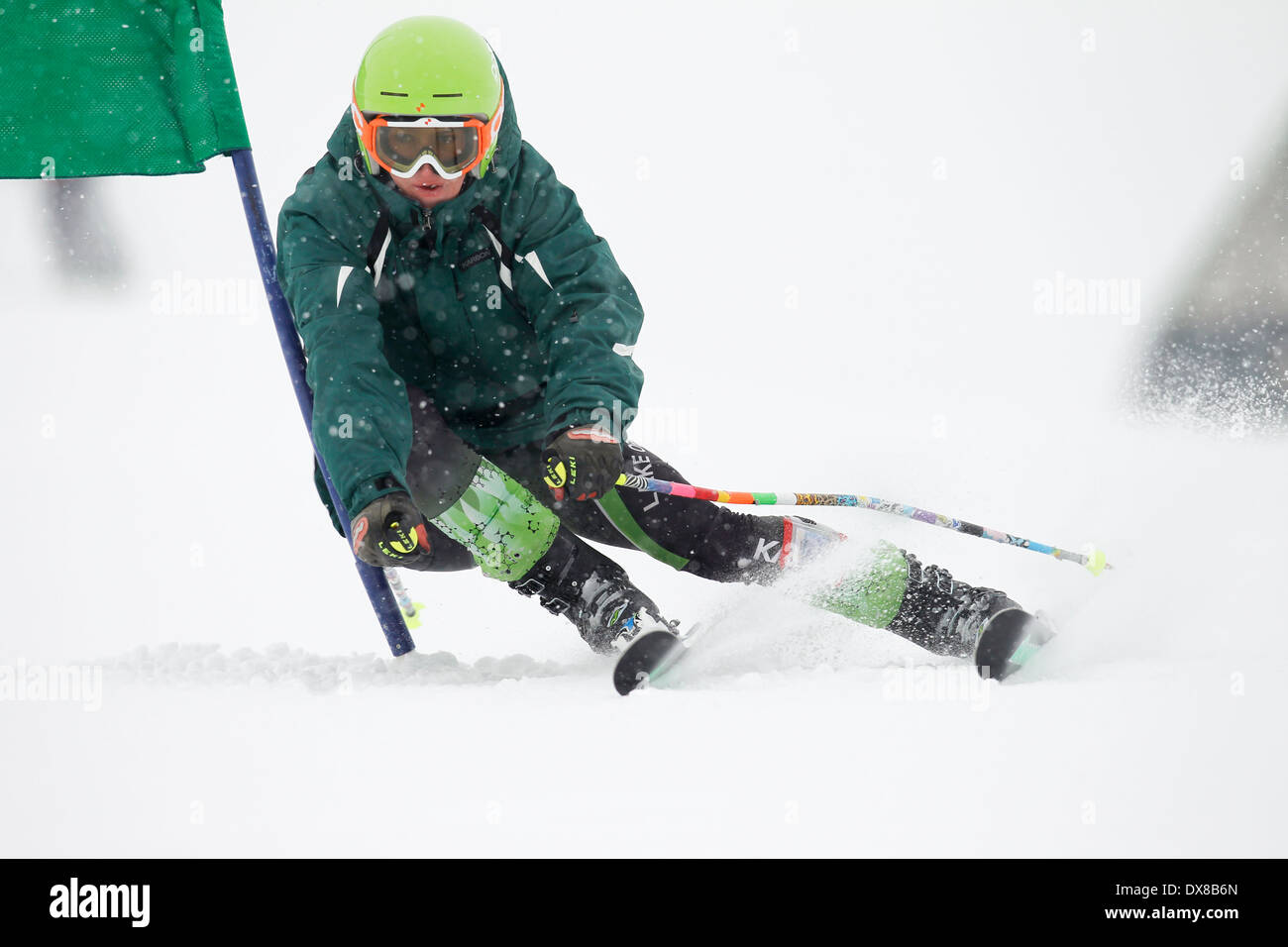 An alpine skier rounding a gate while racing on the giant slalom course ...