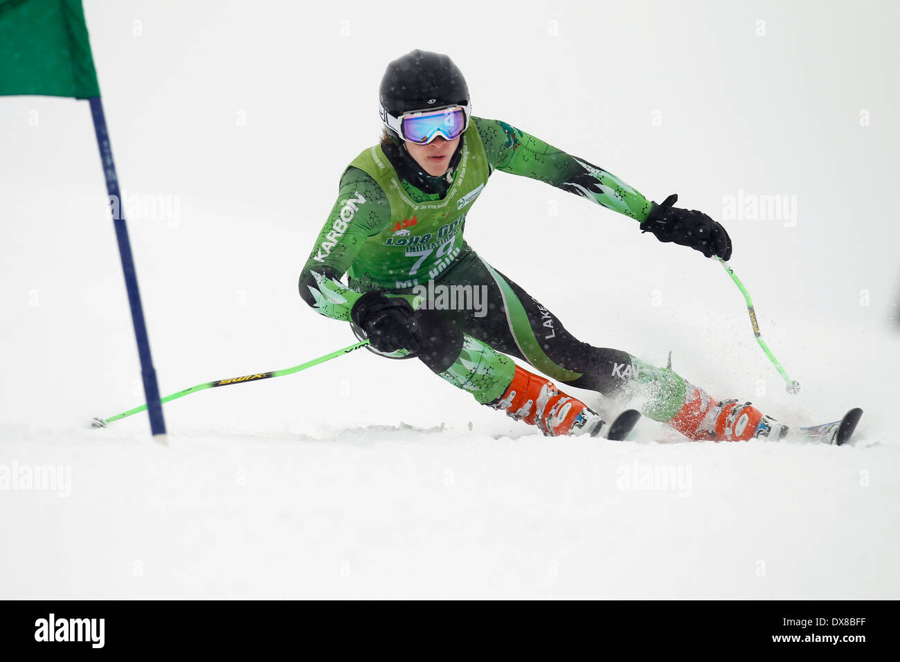A skier turning at a gate while racing on the giant slalom course Stock ...