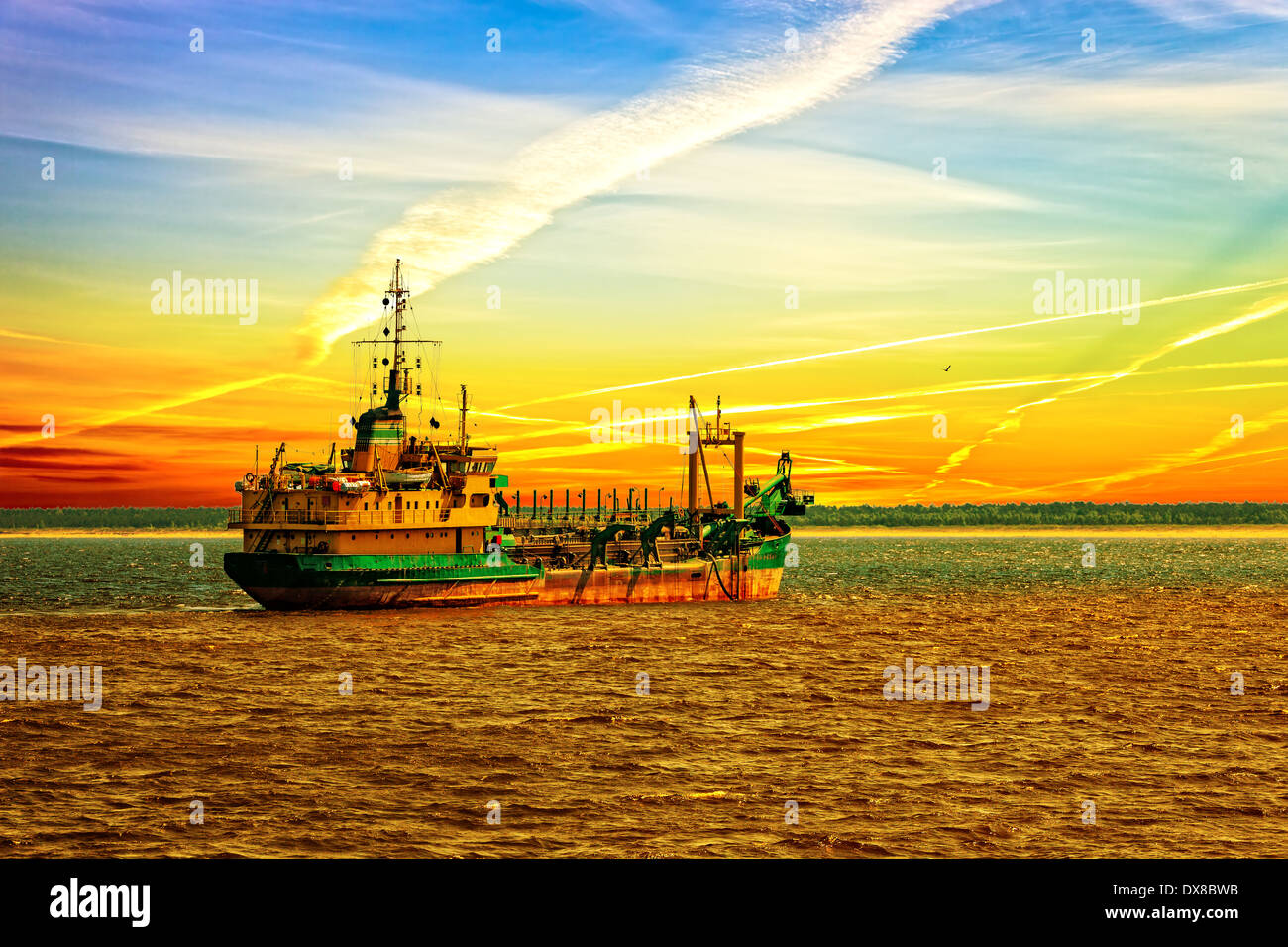 Dredger ship working in the port at sunset Stock Photo - Alamy
