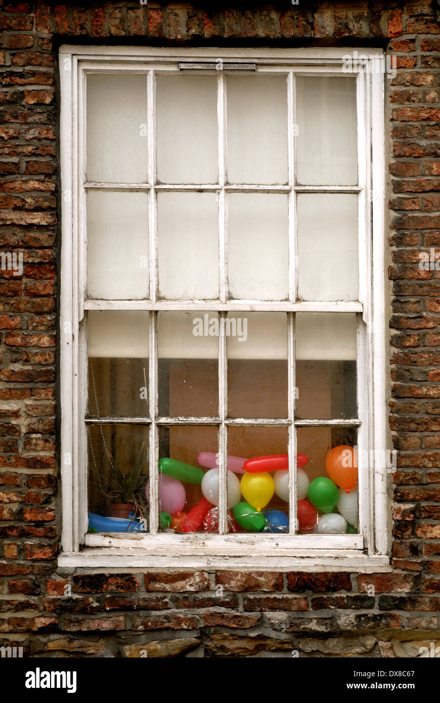 Balloons in window Stock Photo - Alamy