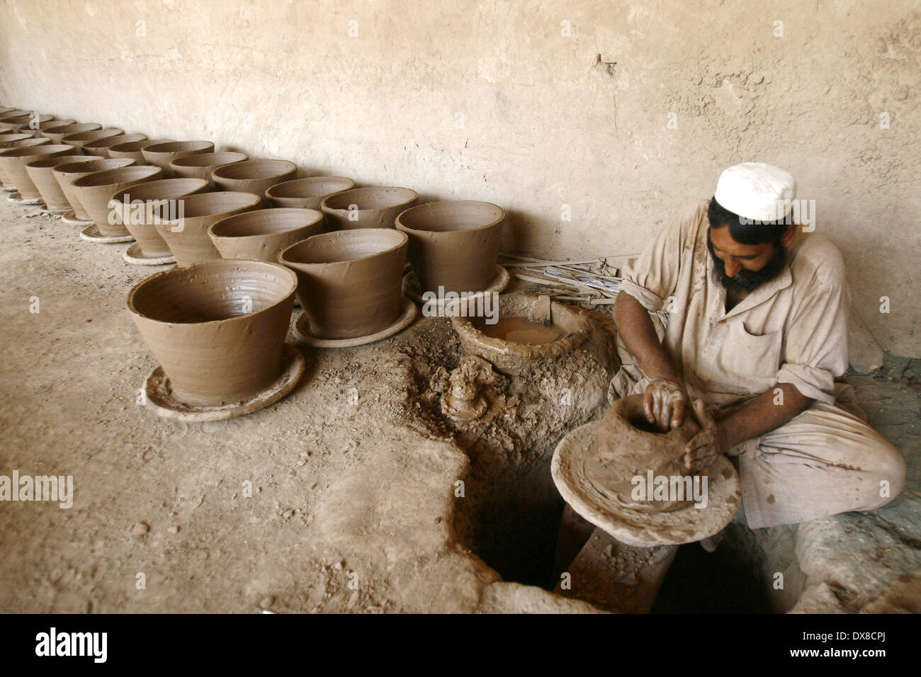 Peshawar, Pakistan. 20th Mar, 2014. A man makes traditional pottery ...