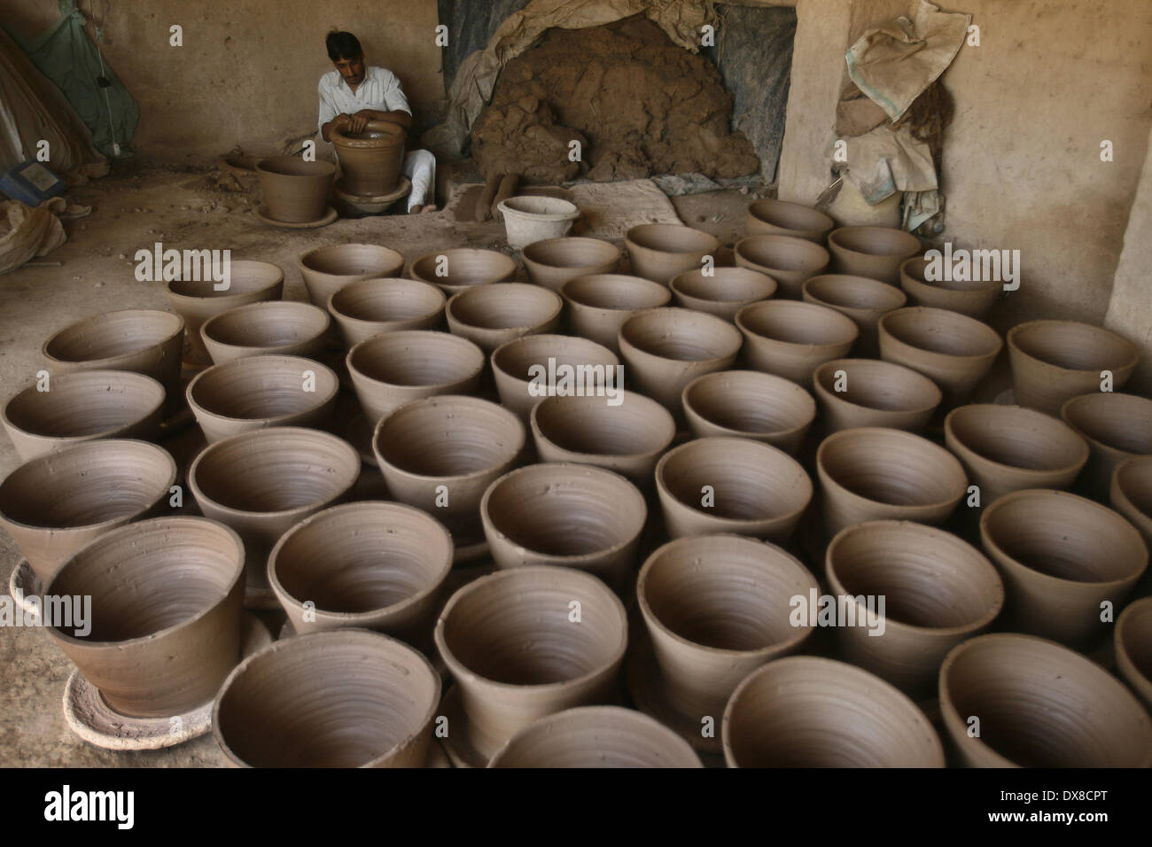 Peshawar, Pakistan. 20th Mar, 2014. A man makes traditional pottery ...