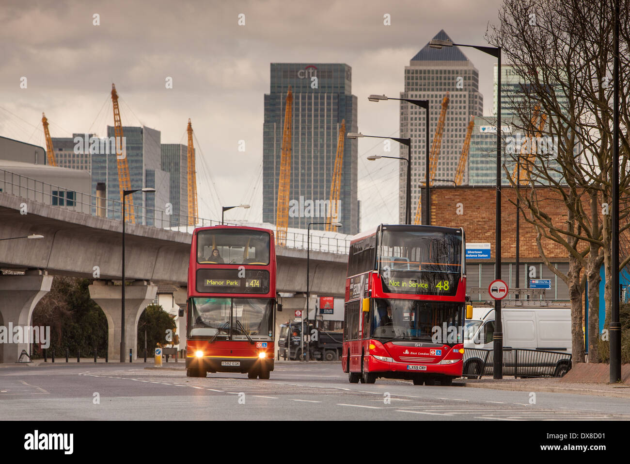 London red buses in East London with Canary wharf, the Dome and the DLR ...