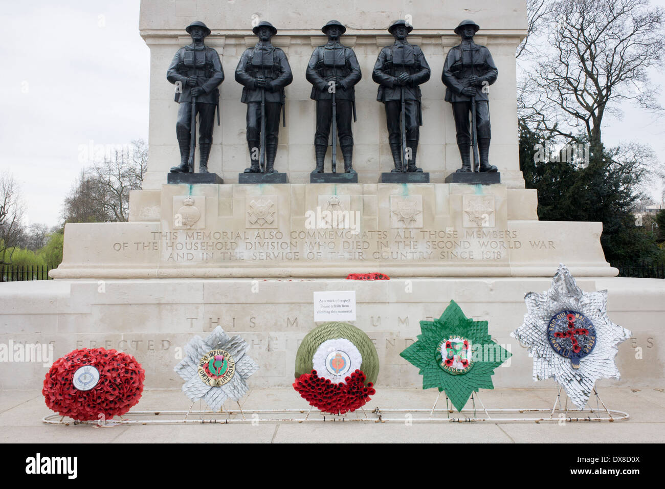 Wreaths with Five soldiers standing at ease on the memorial to both ...