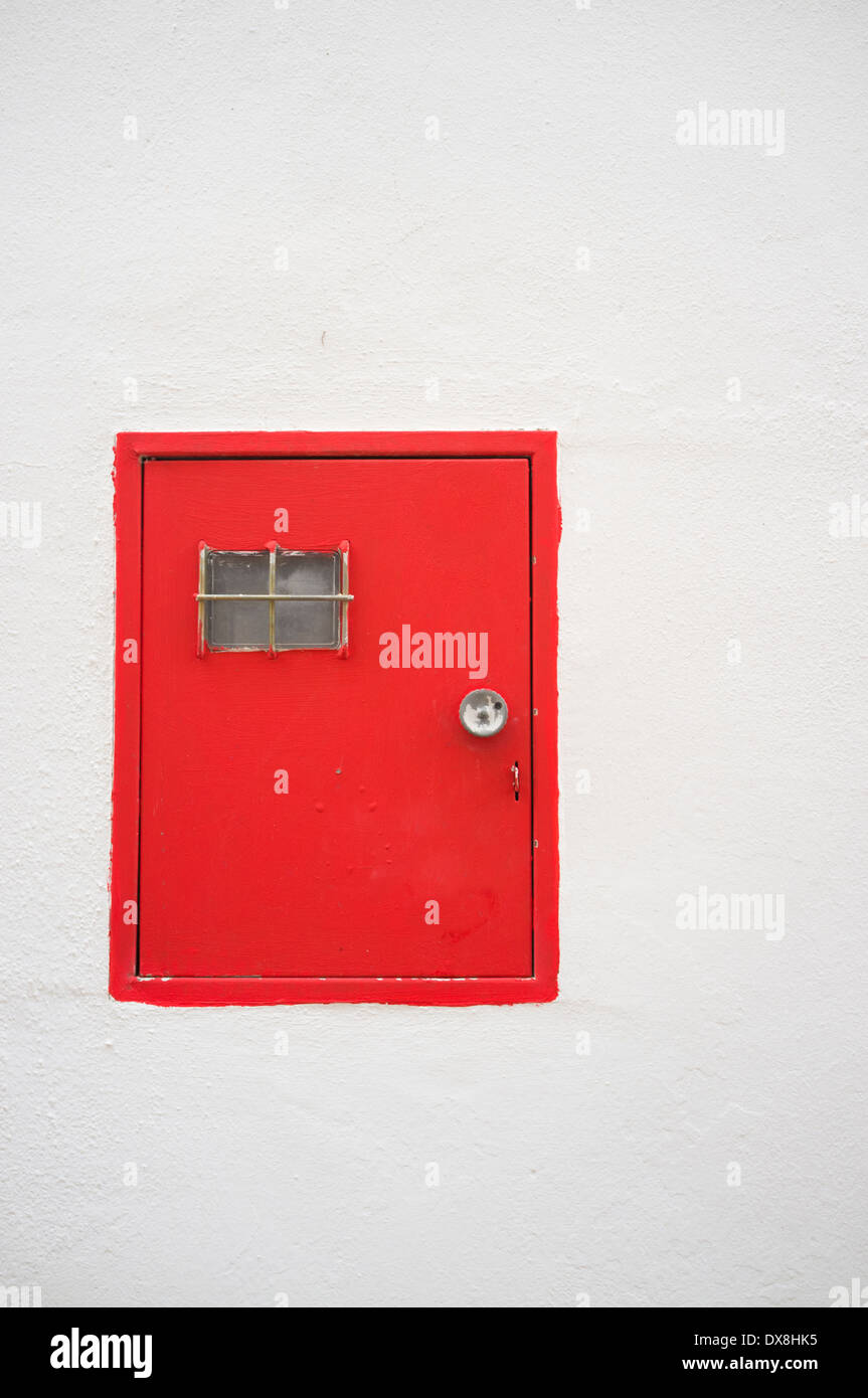 Red electricity meter door on a whitewashed Andalusian facade Stock ...