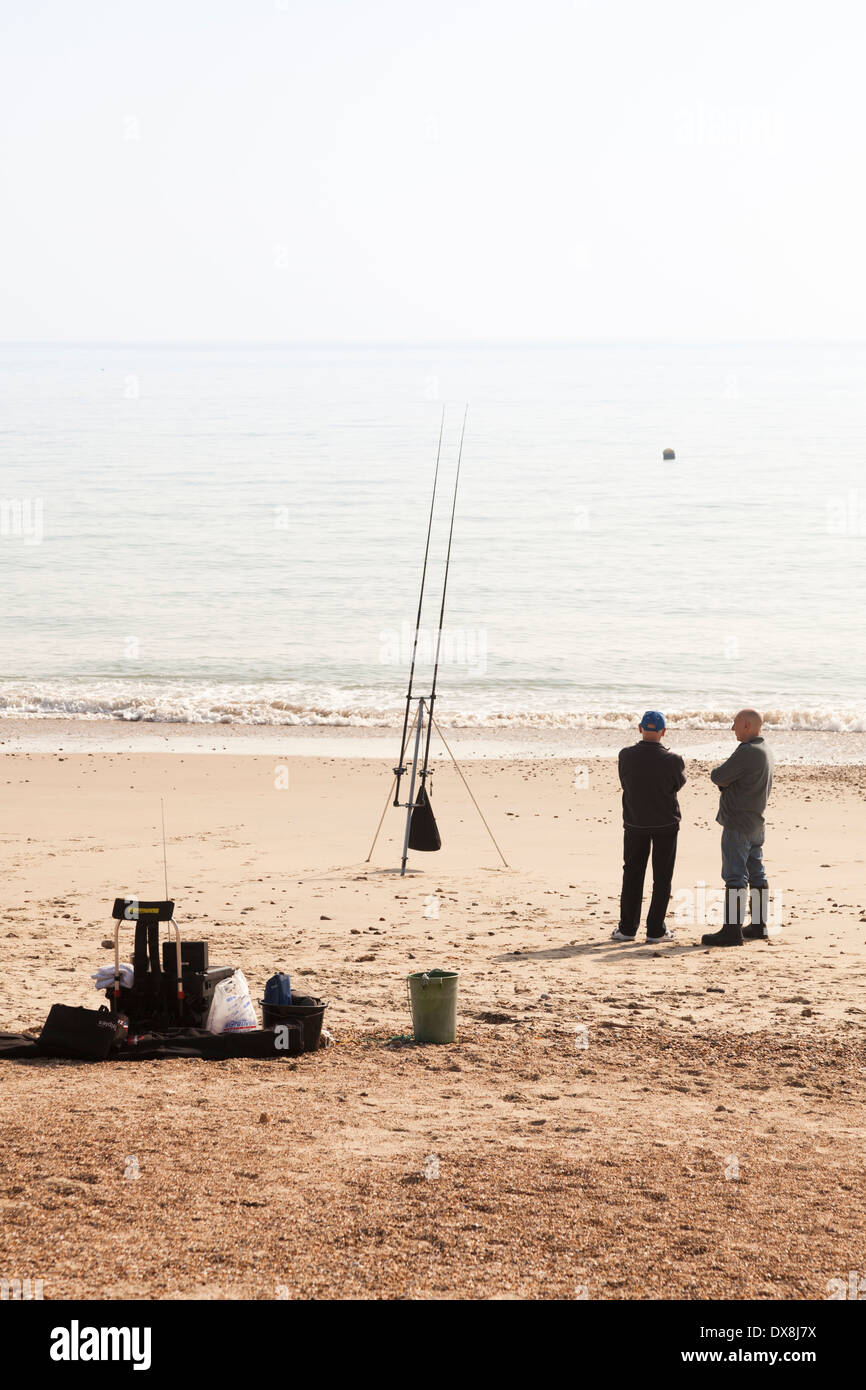 Two men sea fishing from beach Stock Photo - Alamy
