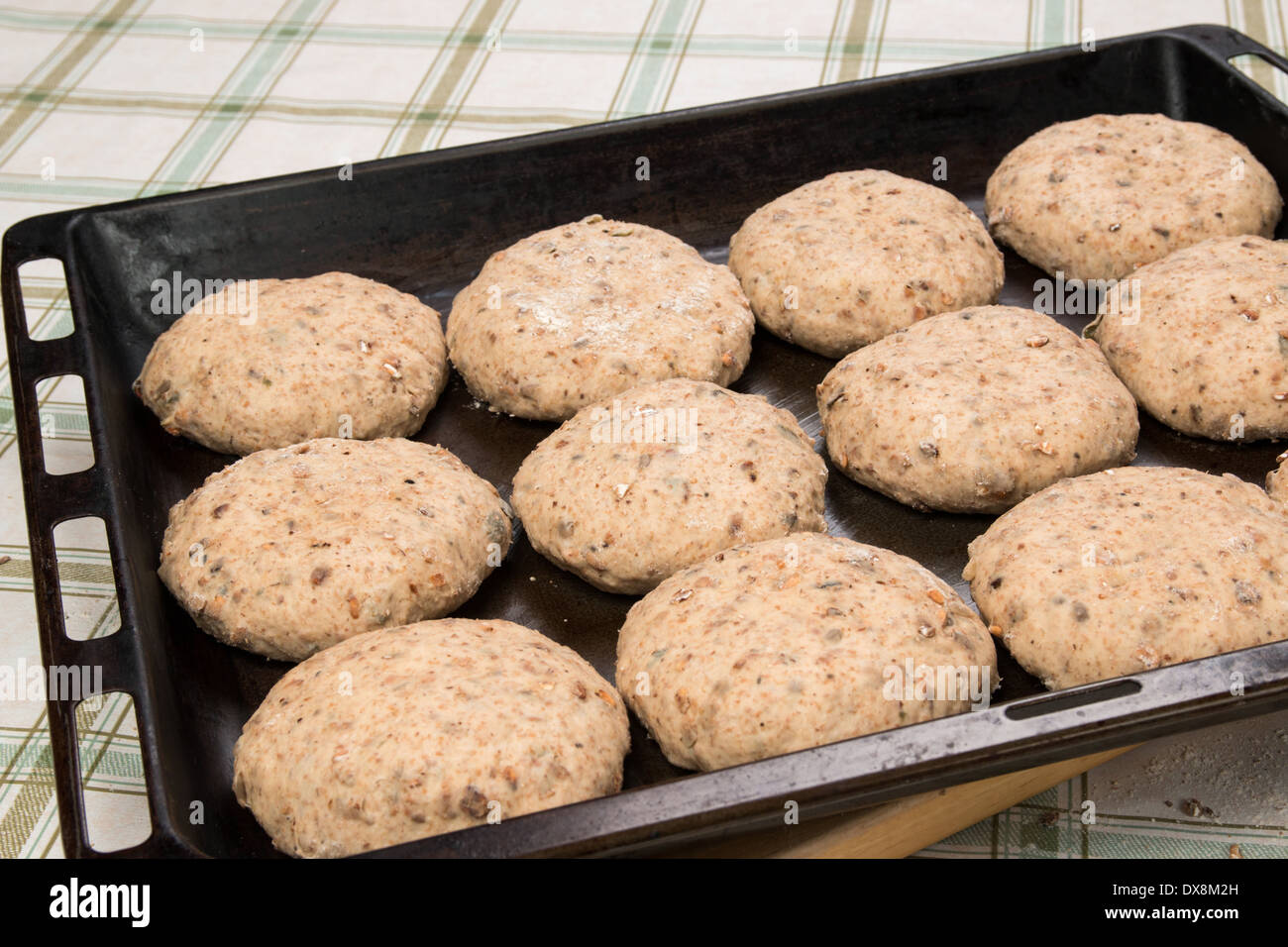 brown Granary bread bun/baps/cakes well risen ready for oven on a ...
