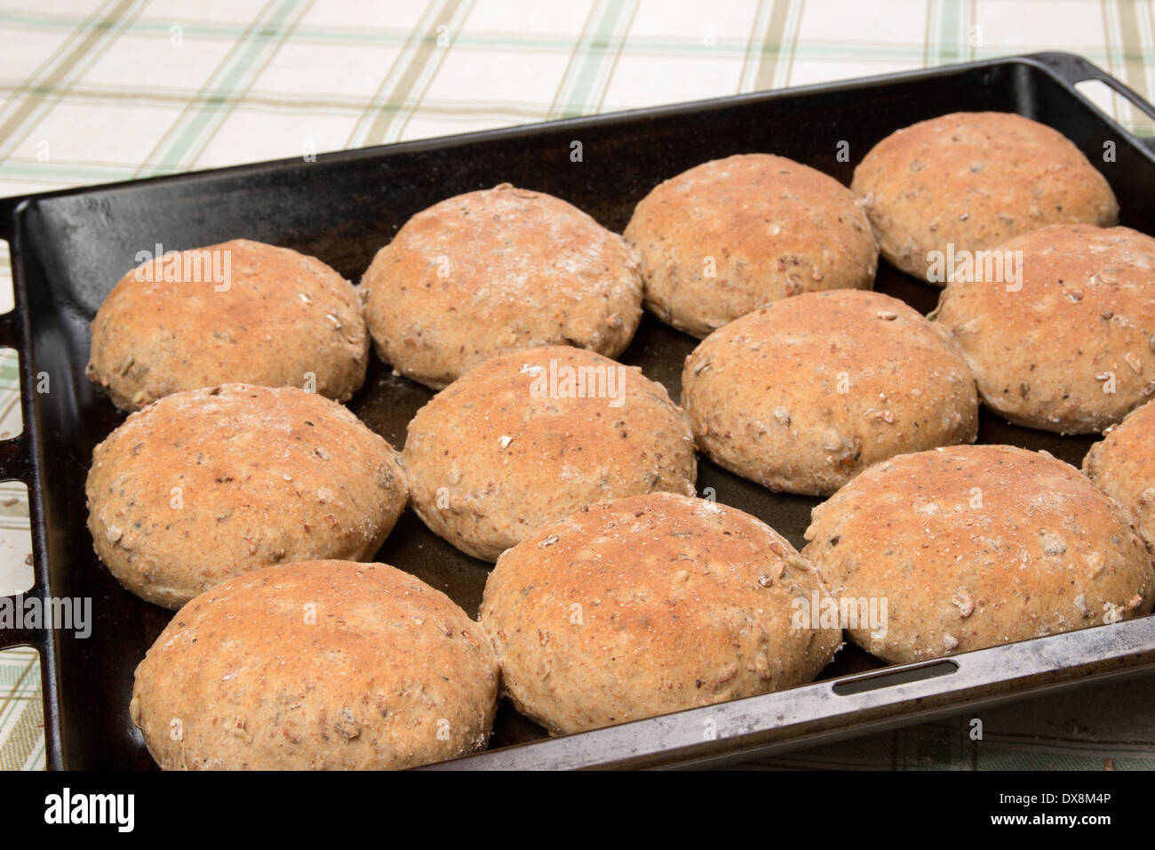brown Granary bread bun/baps/cakes just out of oven, on a baking sheet ...